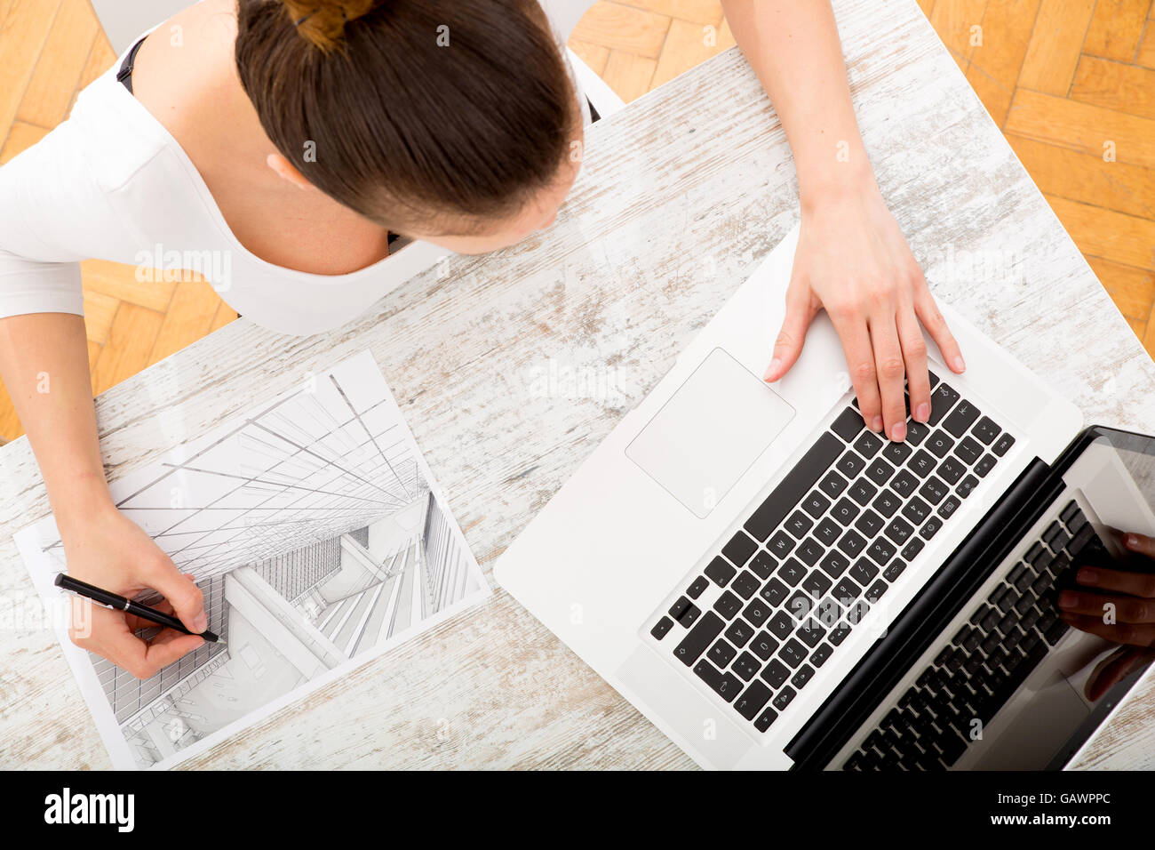 A young adult woman developing a architectural plan at home Stock Photo ...