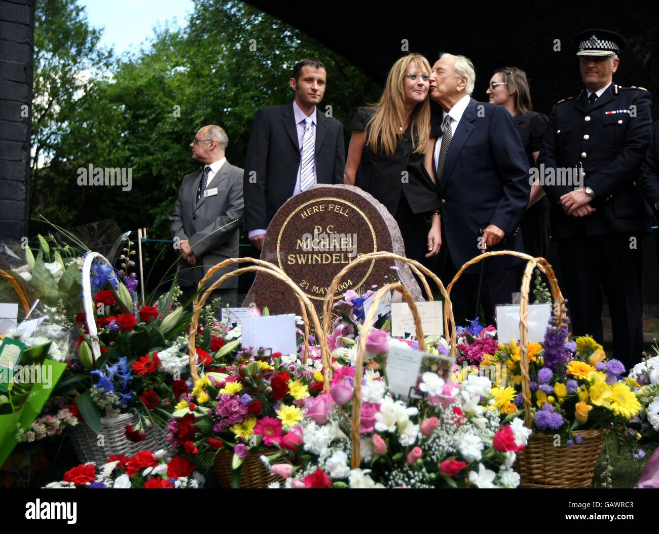 Carol Swindells (centre) receives a kiss from Michael Winner (centre ...