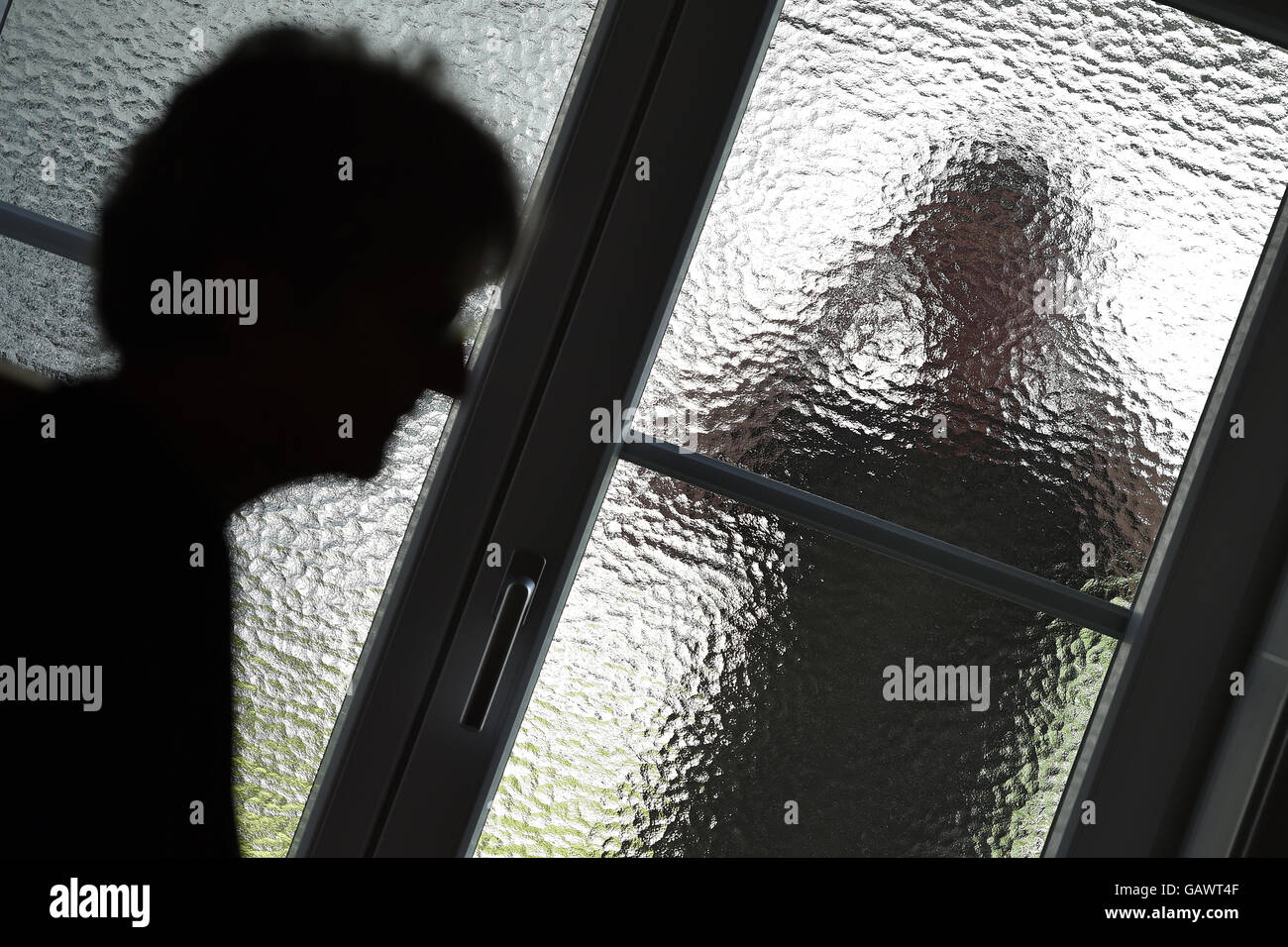 ILLUSTRATION - A stalker looking at a woman through a blurred window in ...