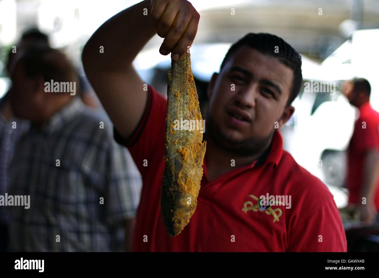 Amman. 5th July, 2016. A Jordanian man sells pickled fish in Amman ...