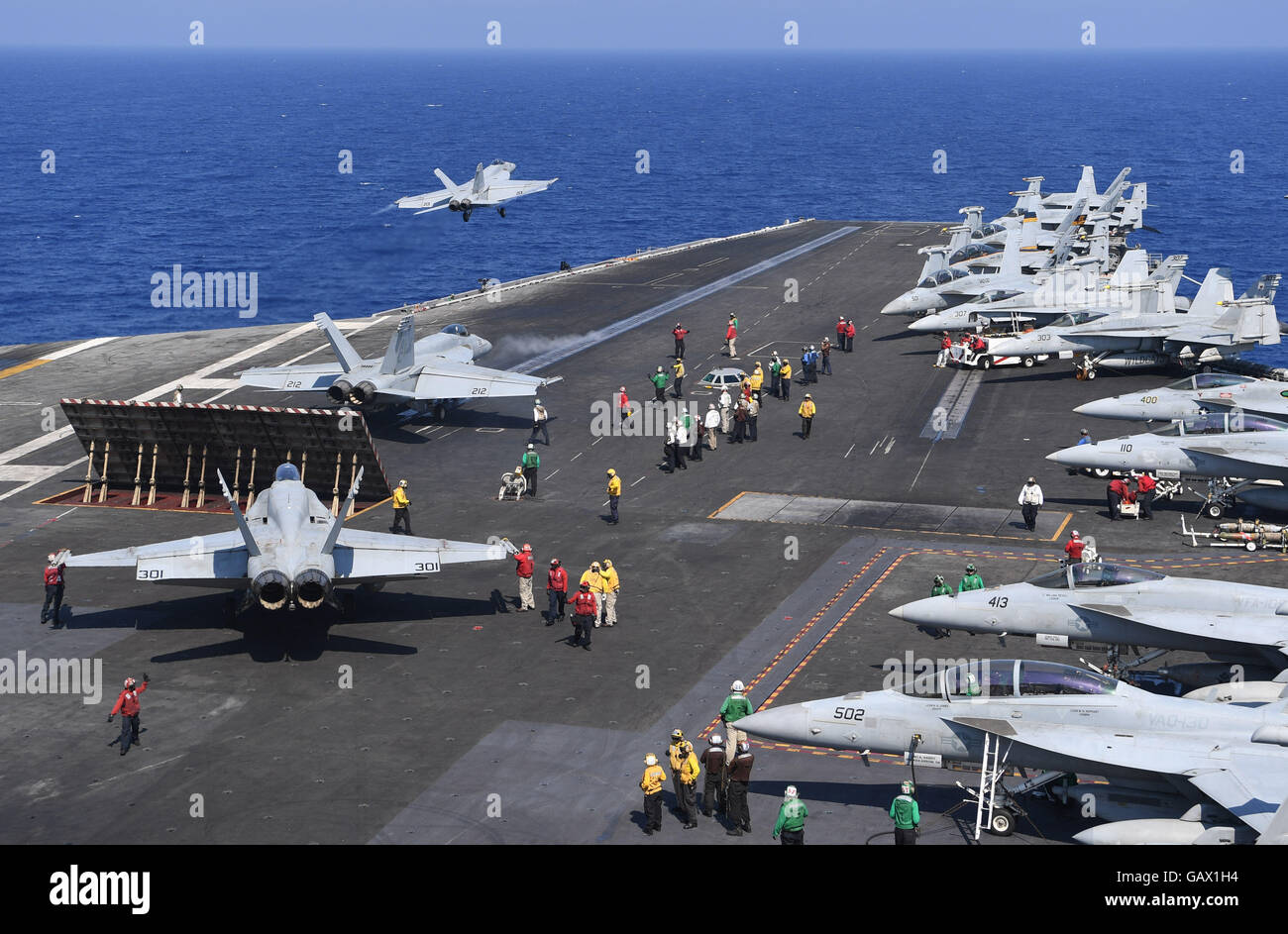 A warplane takes off from the deck of aircraft carrier USS Dwight D ...