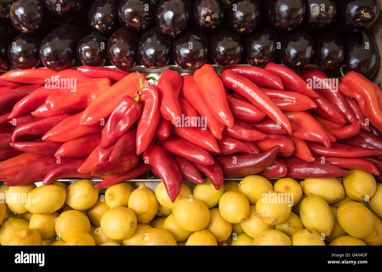 Aubergines, peppers and lemons form a German national flag at a fruit ...