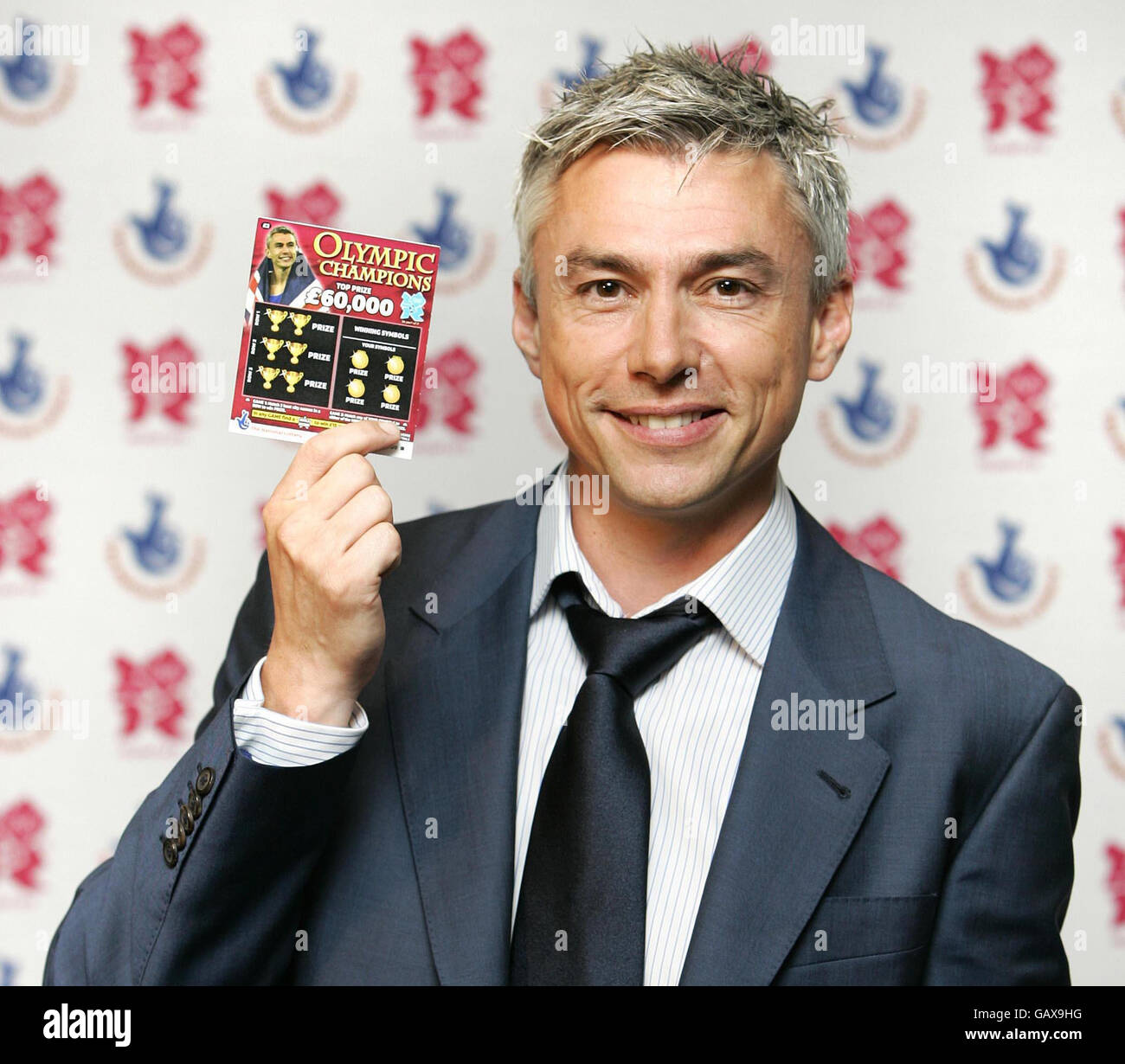 Olympic Gold Medalist Jonathan Edwards holds an Olympic Champions ...