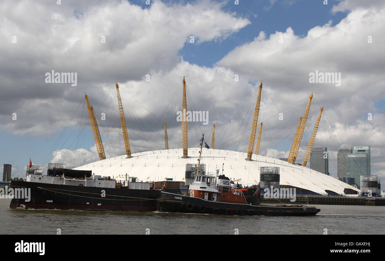 The SS Robin passes the 02 Arena, and Canary Wharf, London, as it is ...