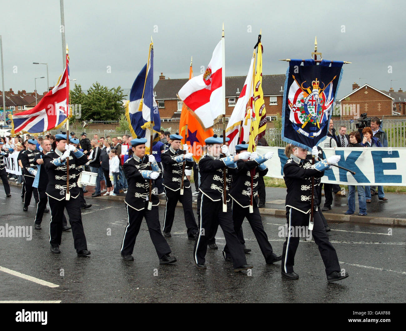 A loyalist band makes its way up the Springfield Road, west Belfast ...