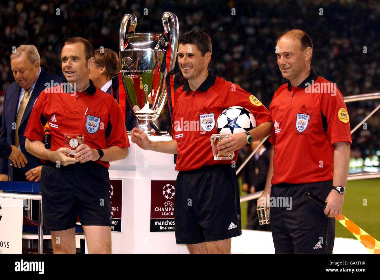 L-R: Assistant referee Christian Schraer, referee Markus Merk and ...