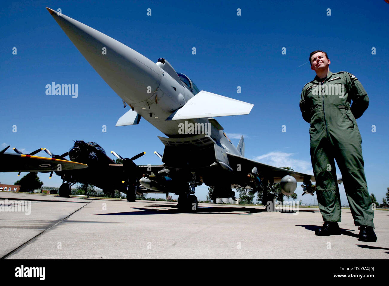 Squadron Leader Mike Baulkwill, Typhoon Squadron, stands alongside a ...