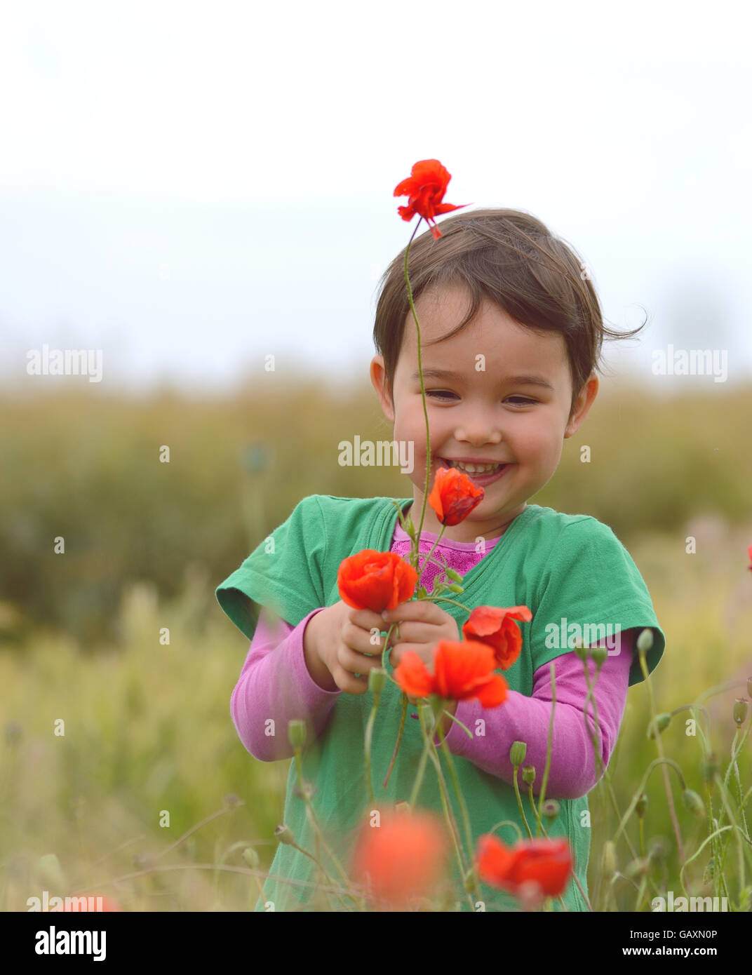 Happy cute child girl on poppies field. Happy children. Healthy ...