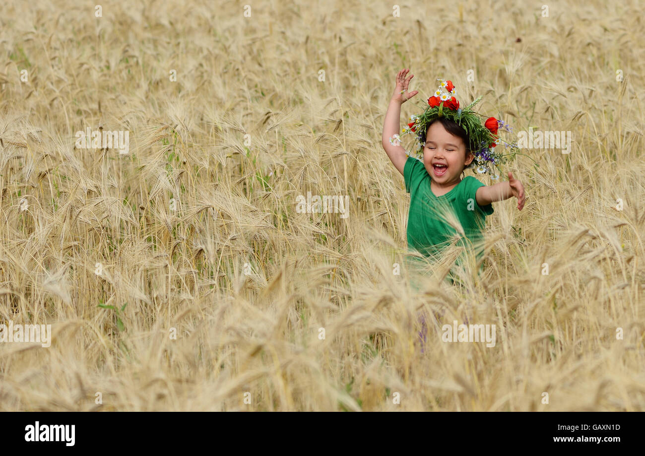 Cute happy baby playing on wheat field Stock Photo - Alamy