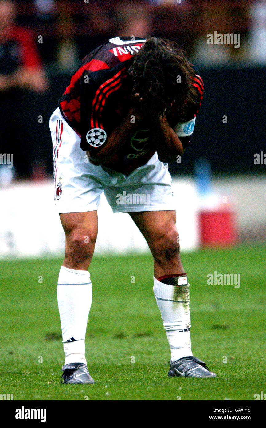 AC Milan's Paolo Maldini holds his head after he received an injury ...
