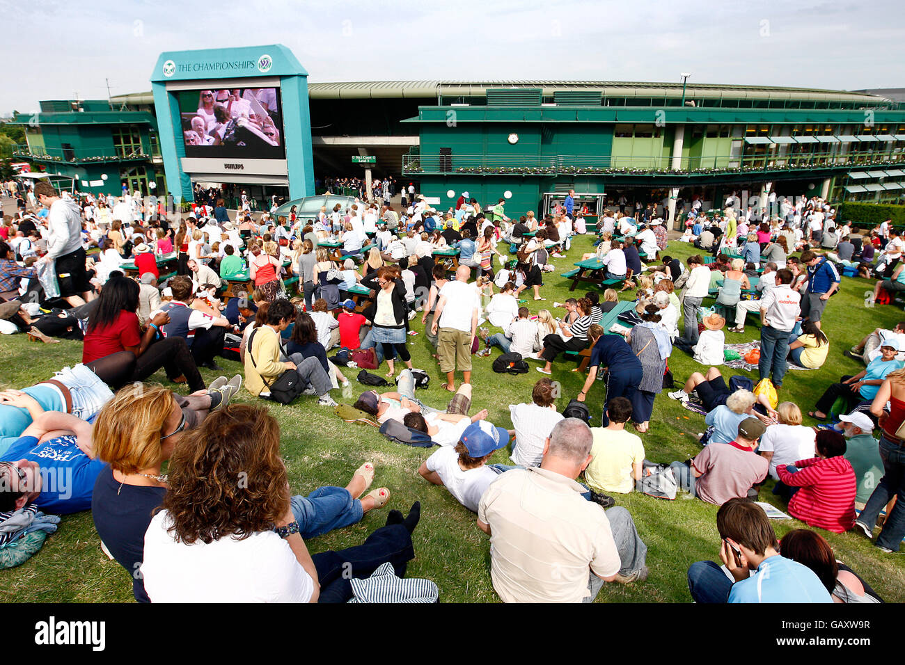 Crowd gathers to watch action from the big screen on hi-res stock ...