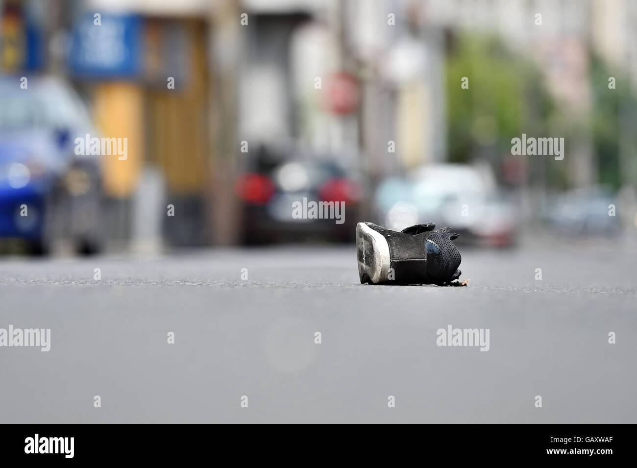 Shoe on the street with cars in background after victim was hit by ...
