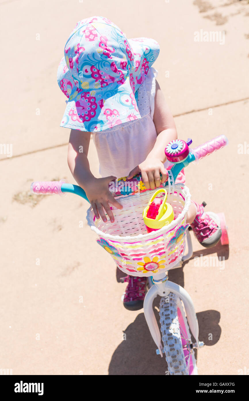 Toddler learning how to ride her first bike Stock Photo - Alamy