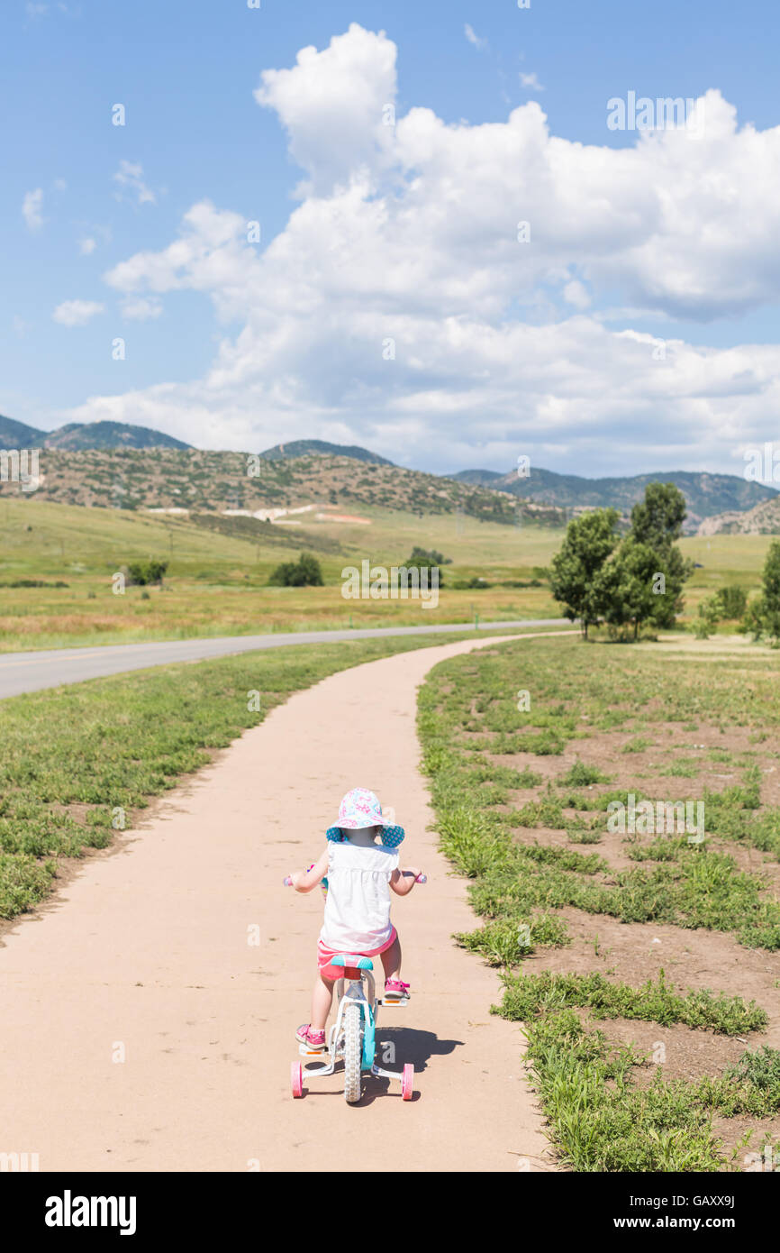 Toddler learning how to ride her first bike Stock Photo - Alamy