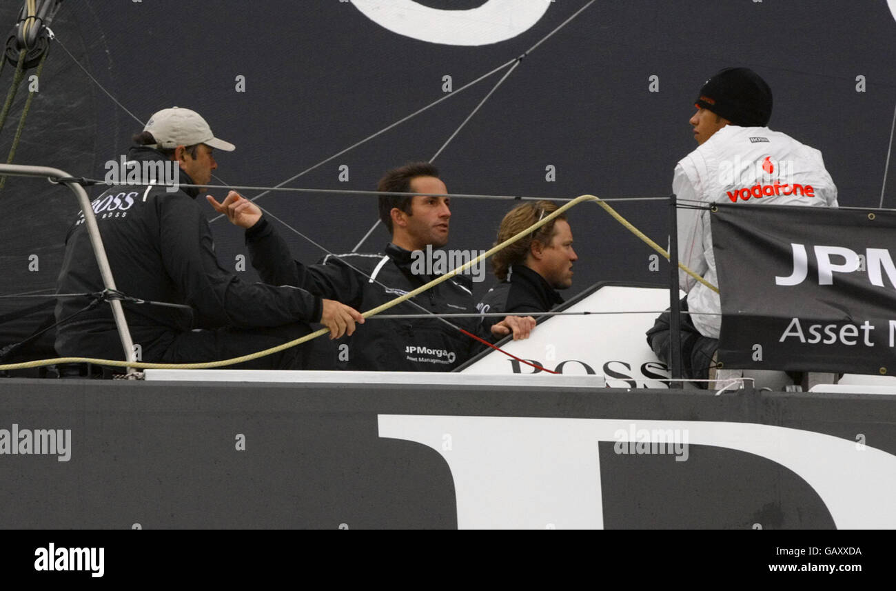 British Formula 1 driver Lewis Hamilton (right) aboard the open 60 ...