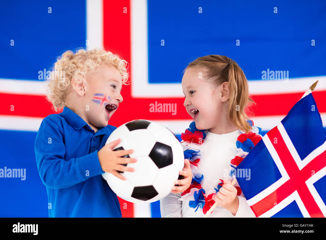 Children cheering and supporting Icelandic national football team. Kids ...