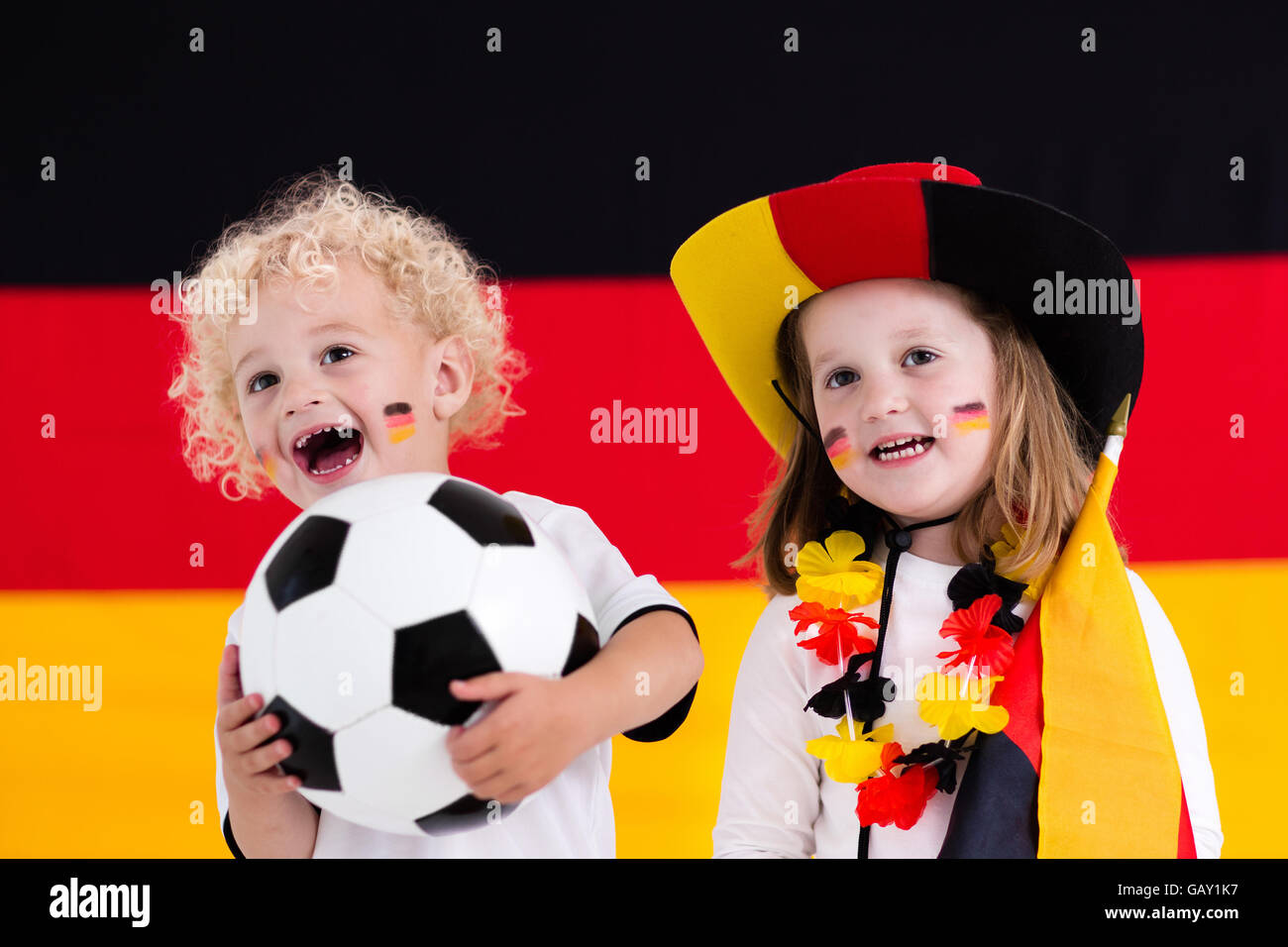 Children cheering and supporting German national football team. Kids ...