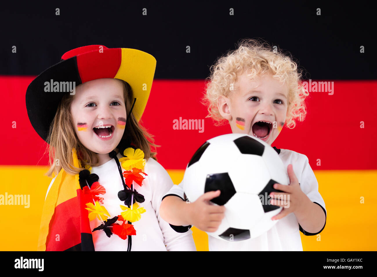 Children cheering and supporting German national football team. Kids ...