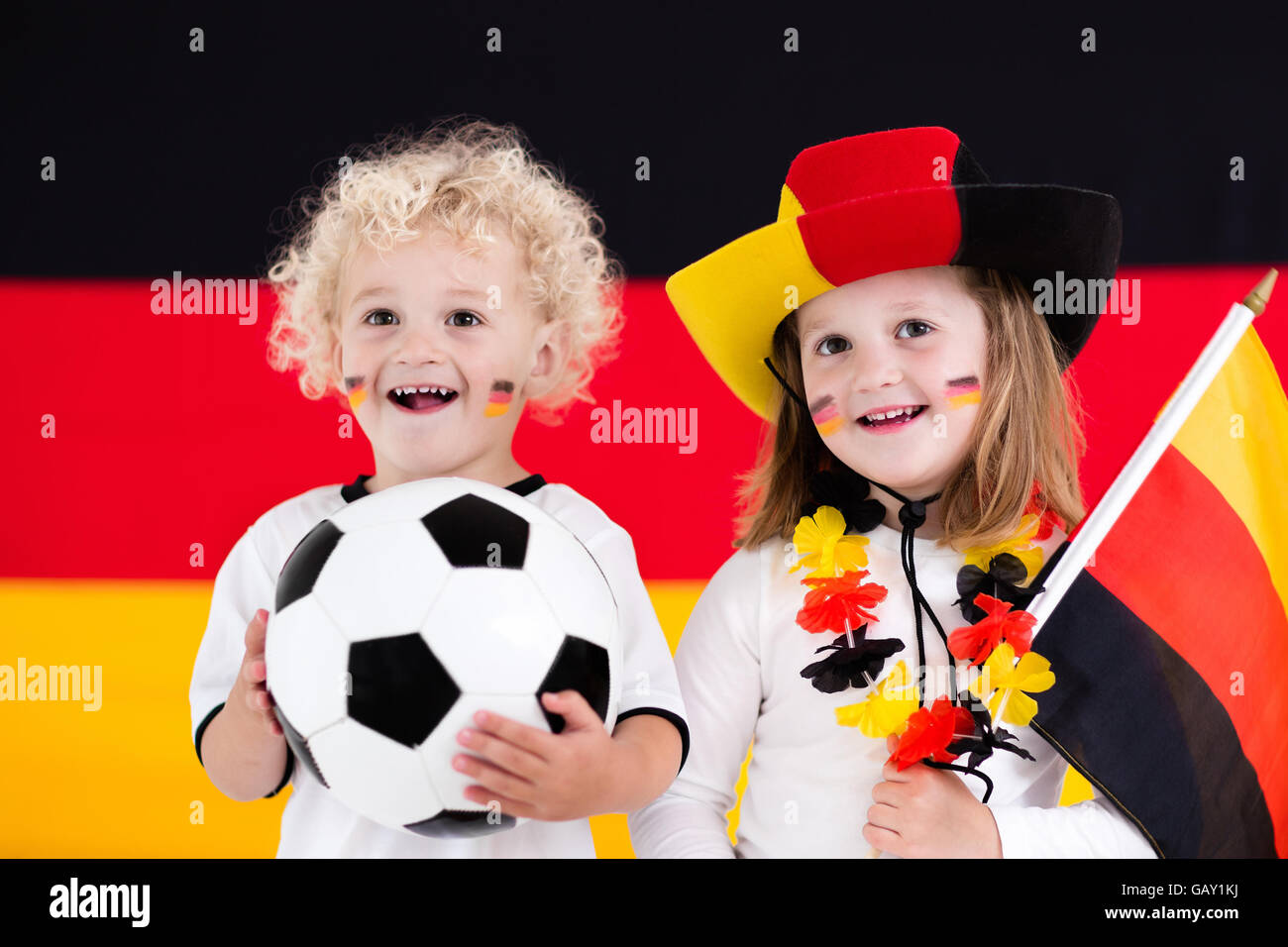 Children cheering and supporting German national football team. Kids ...