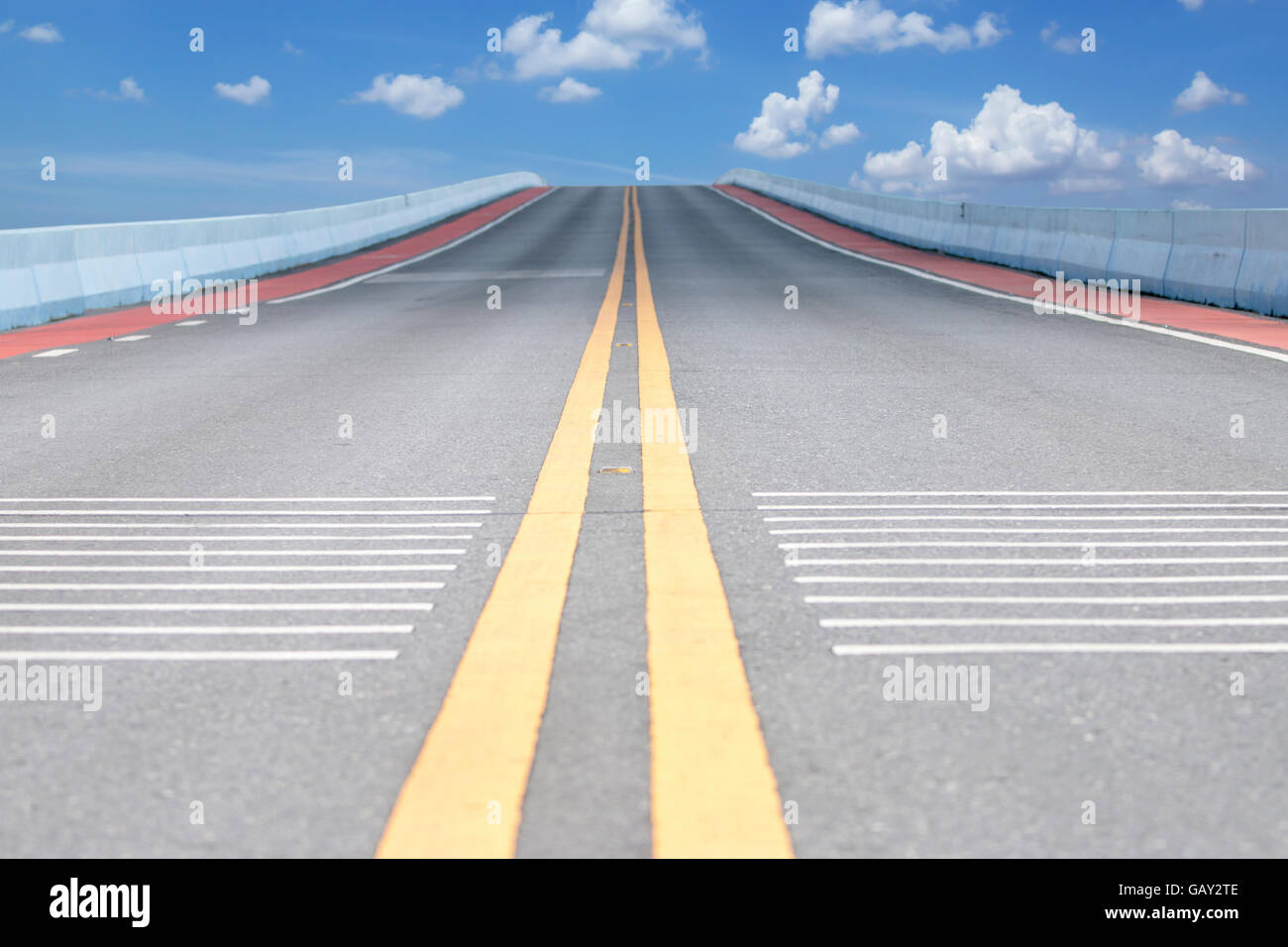Highway and cloud on blue sky background Stock Photo - Alamy