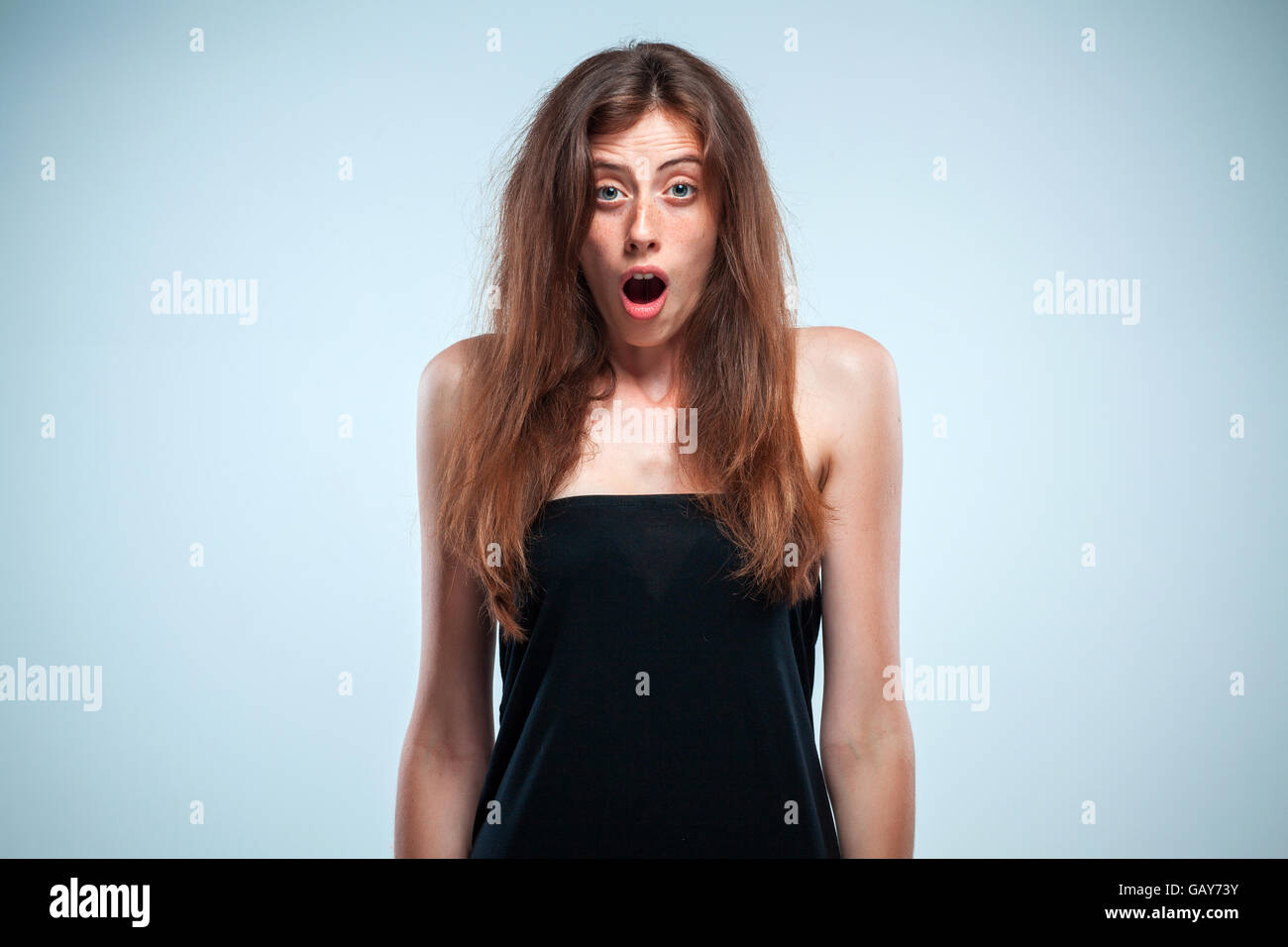 Portrait of young woman with shocked facial expression Stock Photo - Alamy