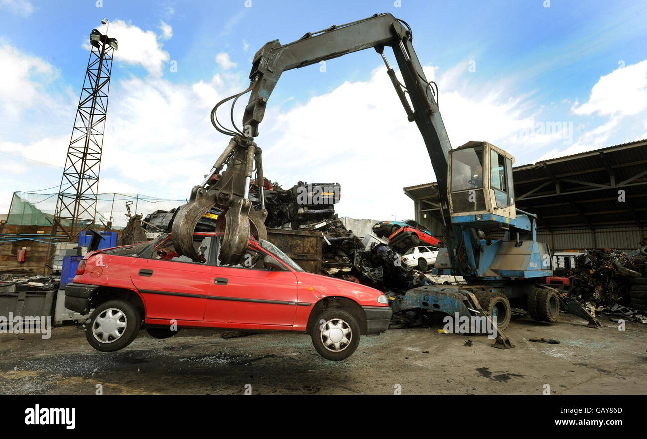 A giant mechanicial grabber lifts car in air hi-res stock photography ...