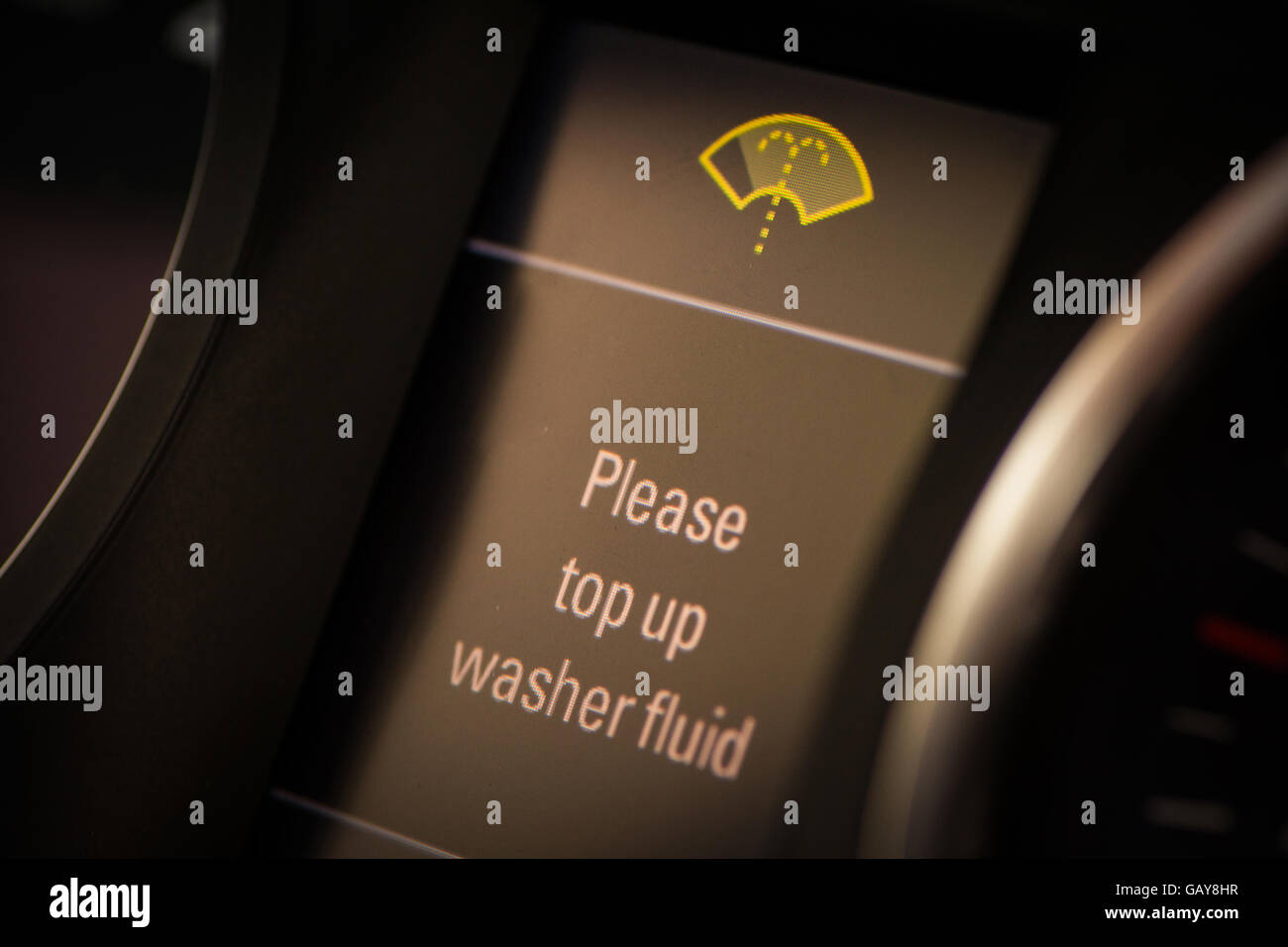 Close-up shot of a car's dashboard, with the wind screen washer icon ...