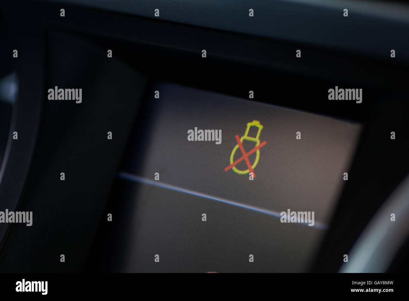 Detail of a car's dashboard, with an alert for a broken light bulb ...