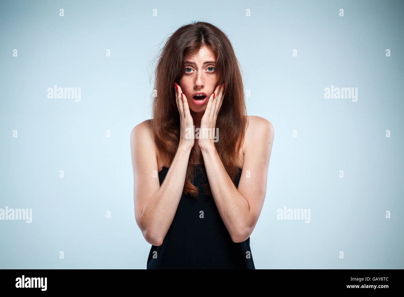 Portrait of young woman with shocked facial expression Stock Photo - Alamy