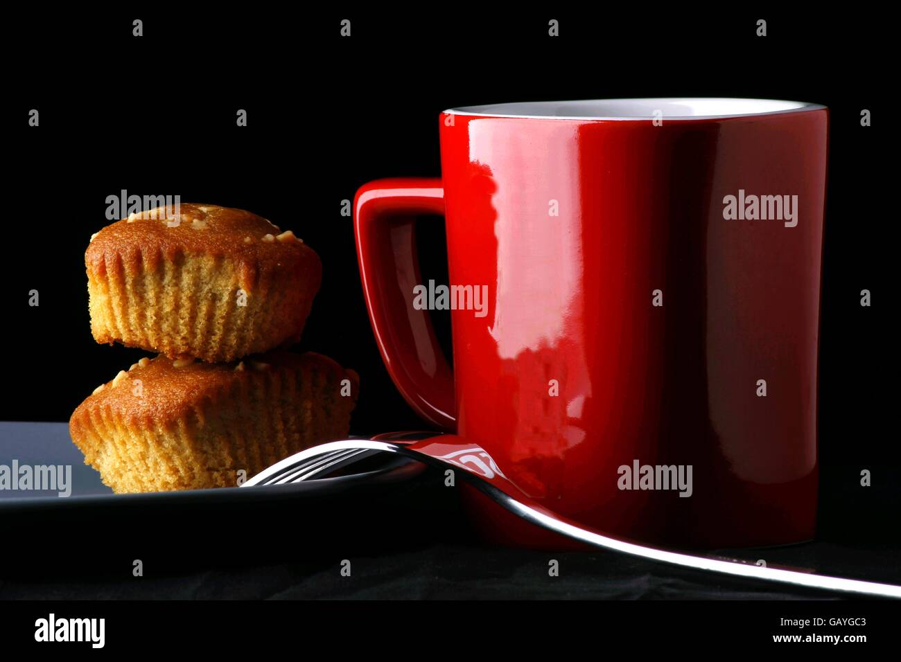 Butterscotch bars on a plate, coffee mug and a fork Stock Photo - Alamy