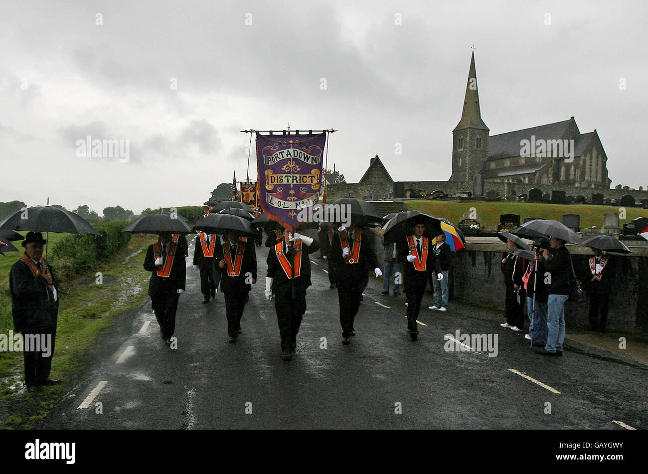 Portadown Orangemen march past Drumcree parish church as the lodge is ...