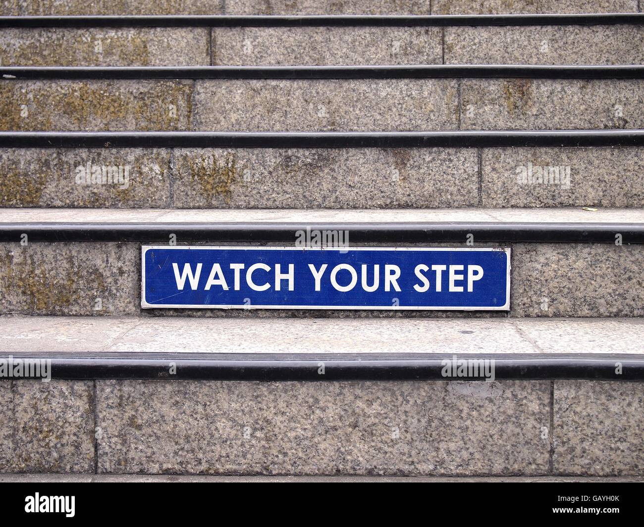 Watch your step sign on a staircase Stock Photo - Alamy