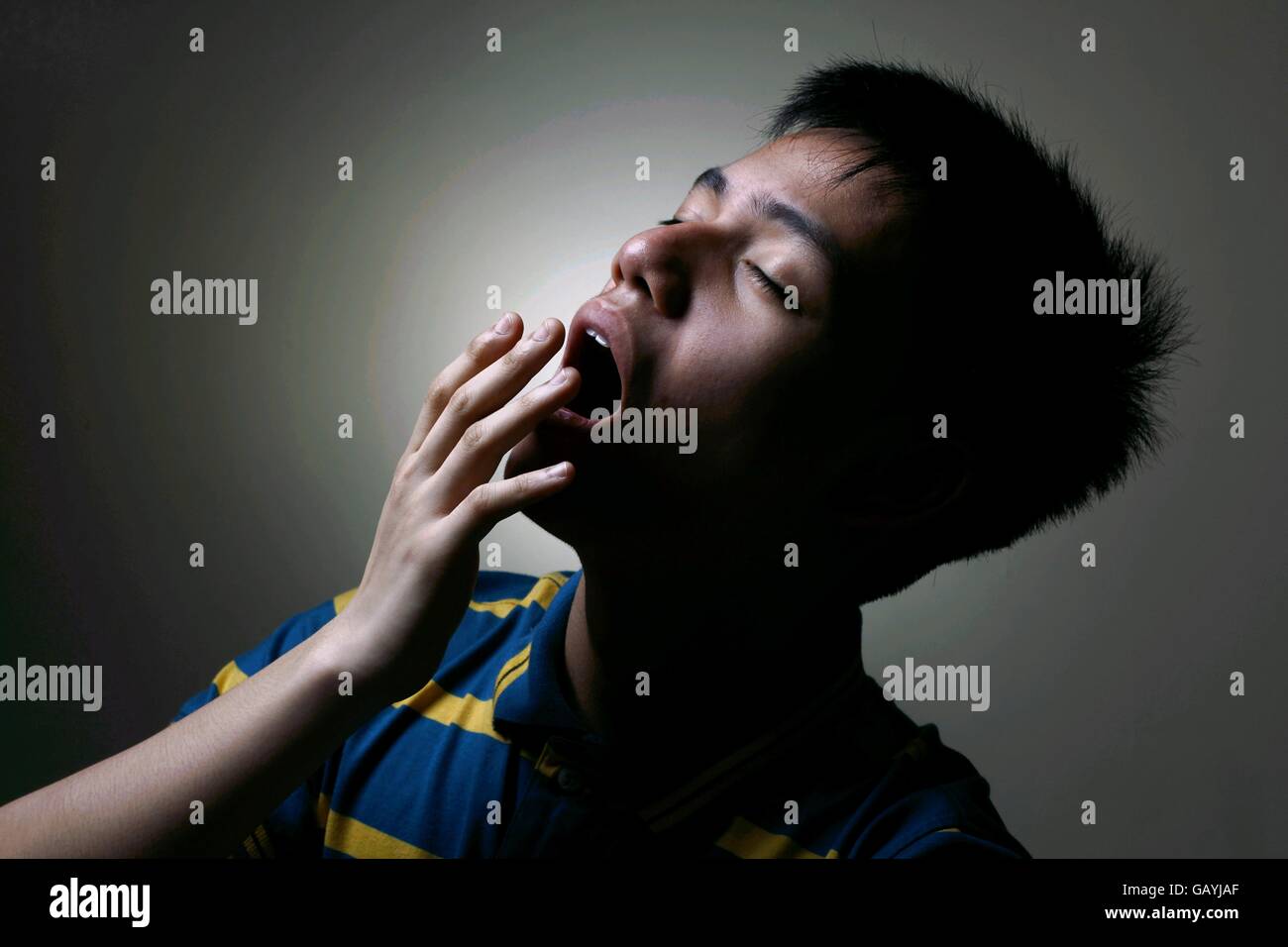 Teenage boy yawning hi-res stock photography and images - Alamy