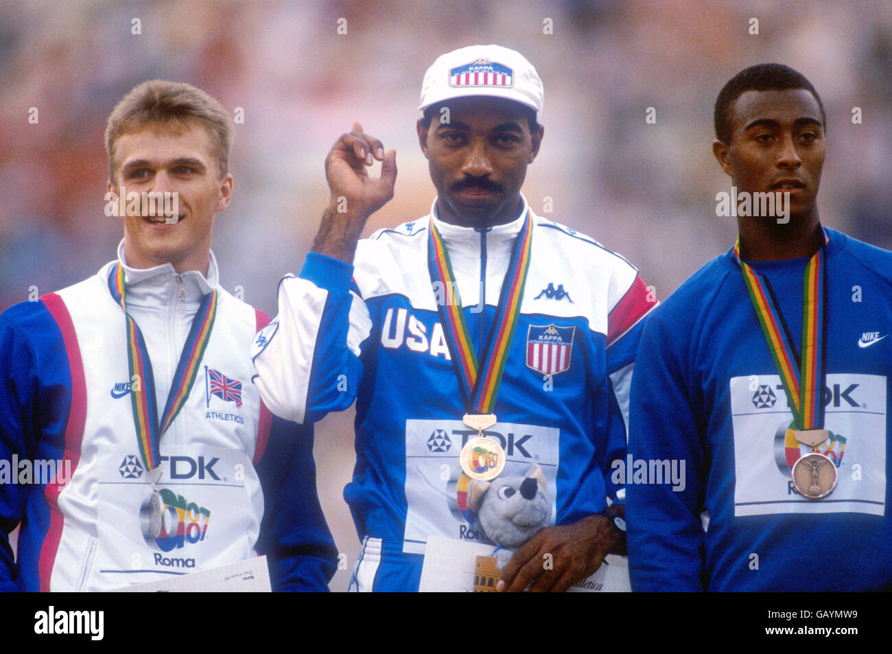 USA's Greg Foster (c) celebrates winning gold as he stands on the ...