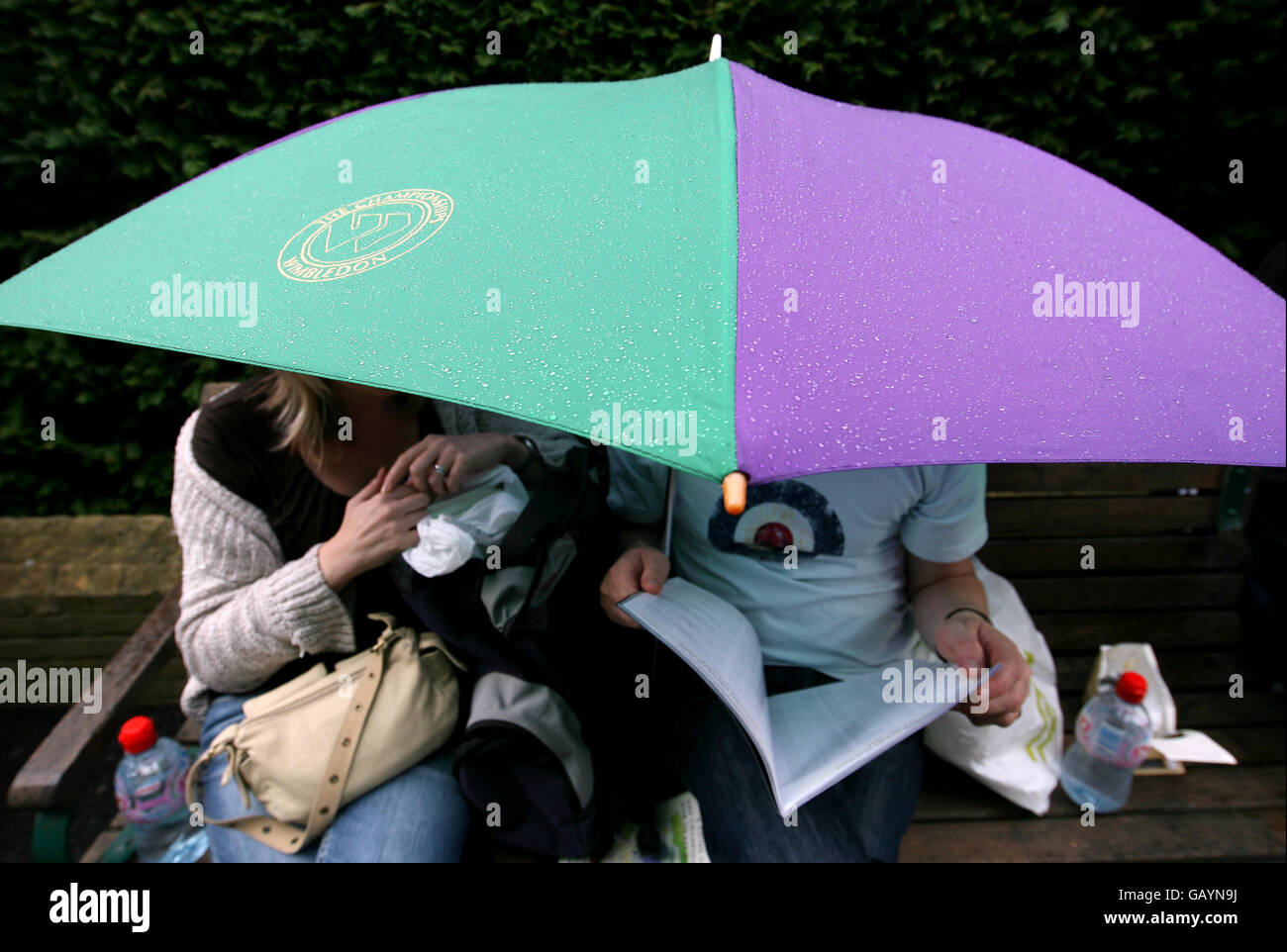 Spectators use umbrellas to protect themselves from the rain Stock ...