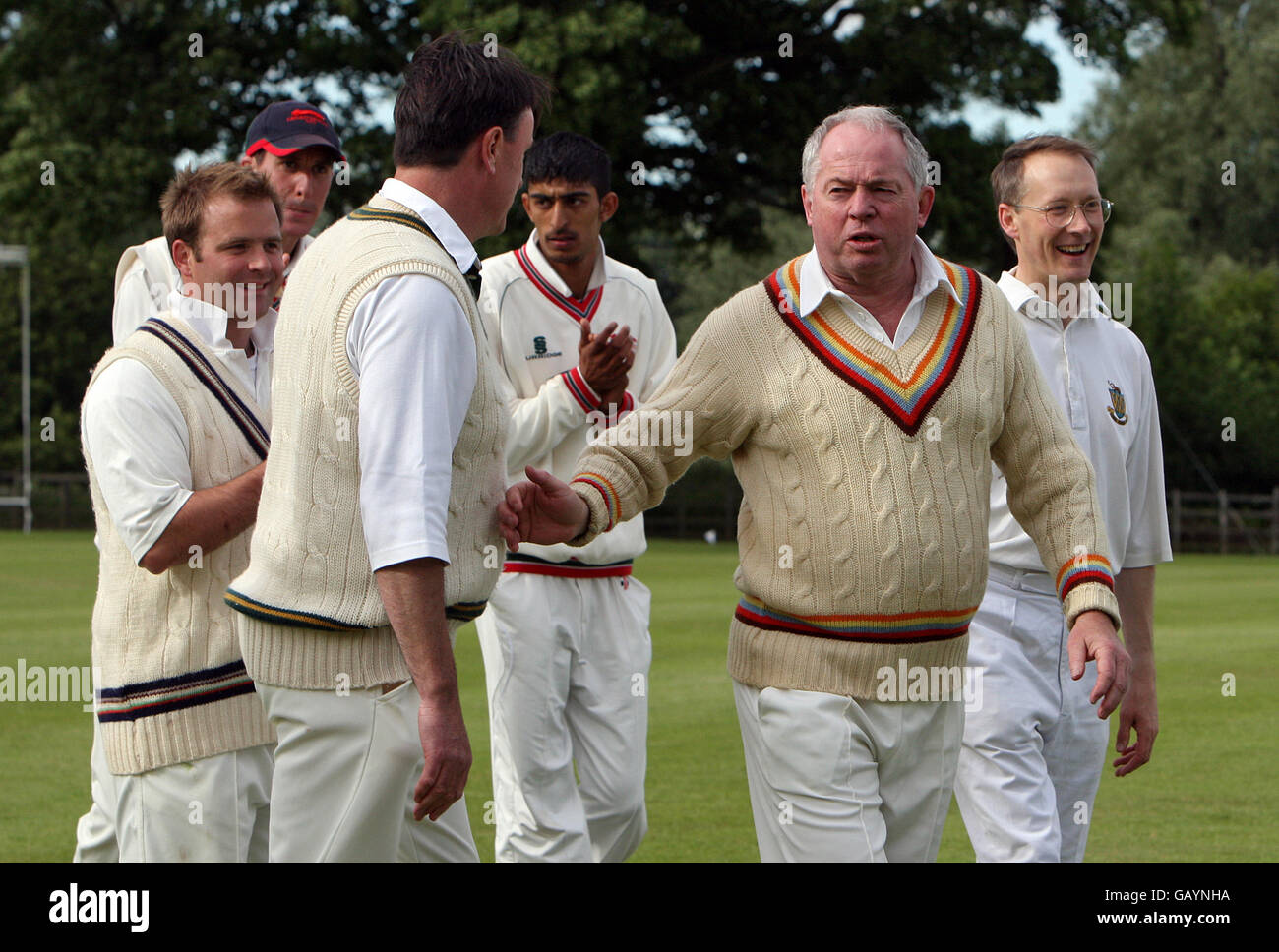 Phillip Hodson (c) and players shake hands and applaud after a charity ...