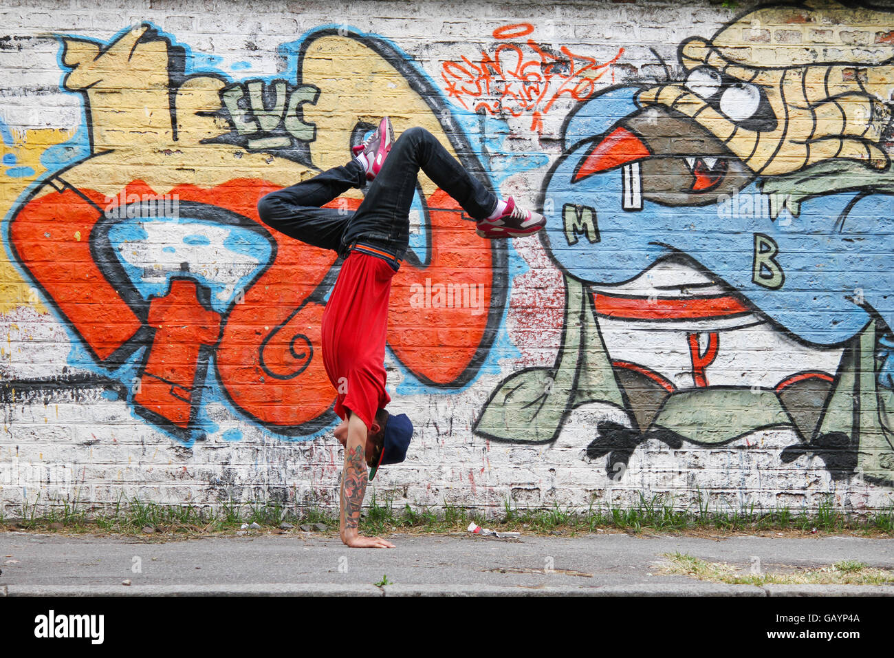 A performing HipHop Dancer in front of a Graffiti wall Stock Photo - Alamy