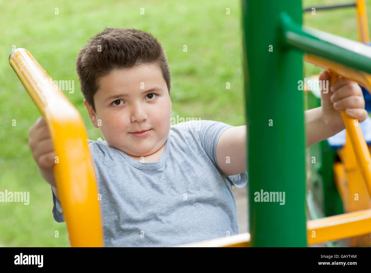 fat boy trains on the simulator in the park Stock Photo - Alamy