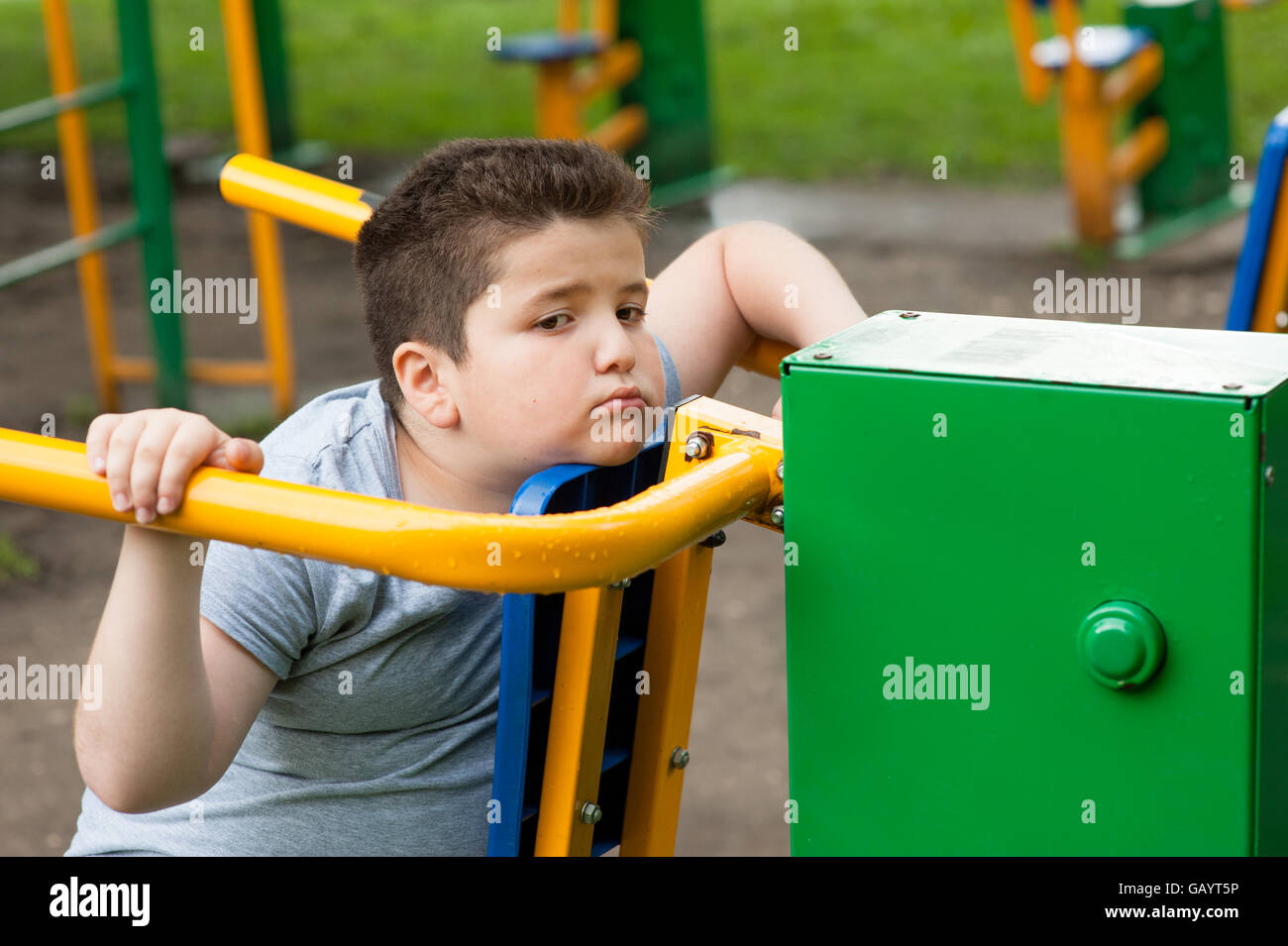 tired sad fat boy sitting on the sports simulator Stock Photo - Alamy