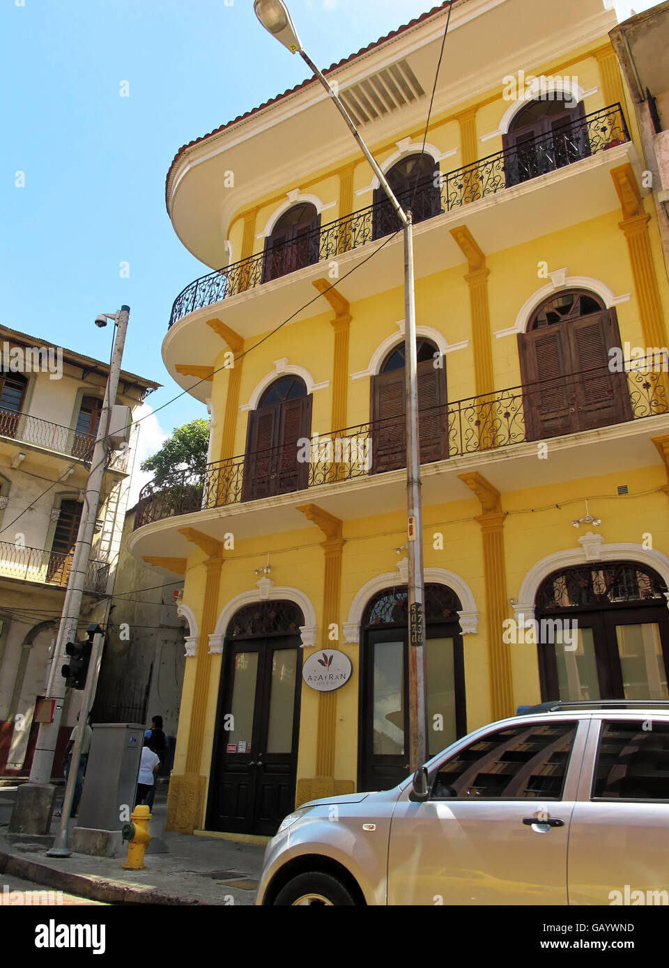 Bright yellow preserved and refurbished building featuring old classic ...