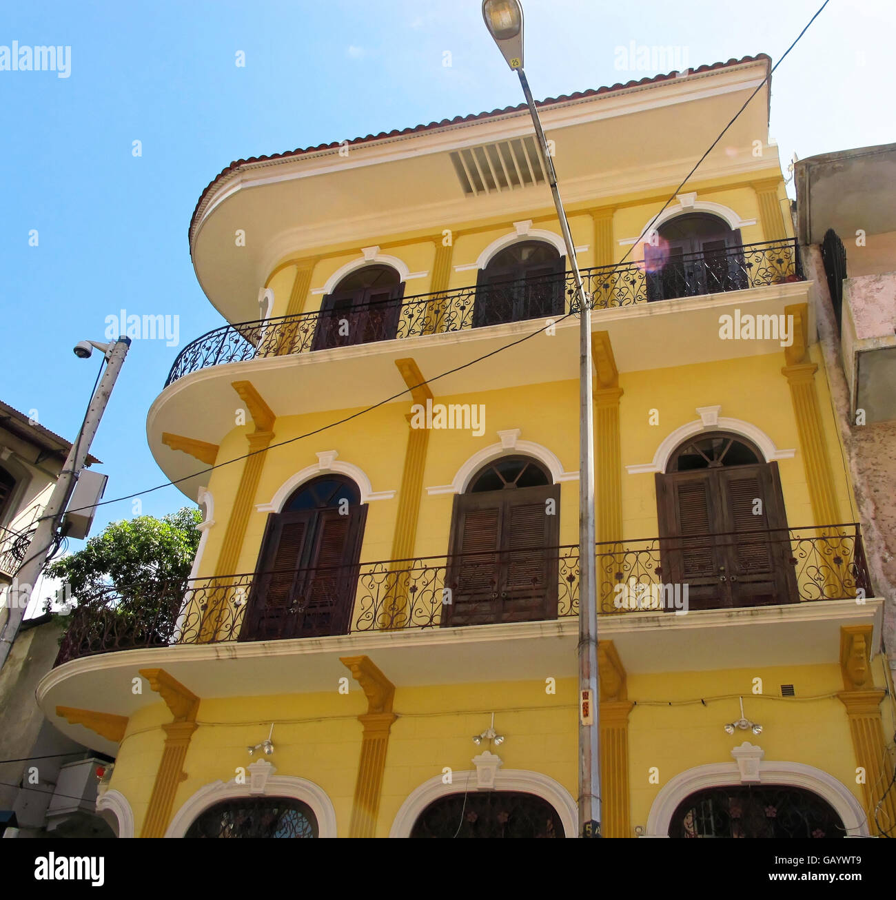 Bright yellow preserved and refurbished building featuring old classic ...