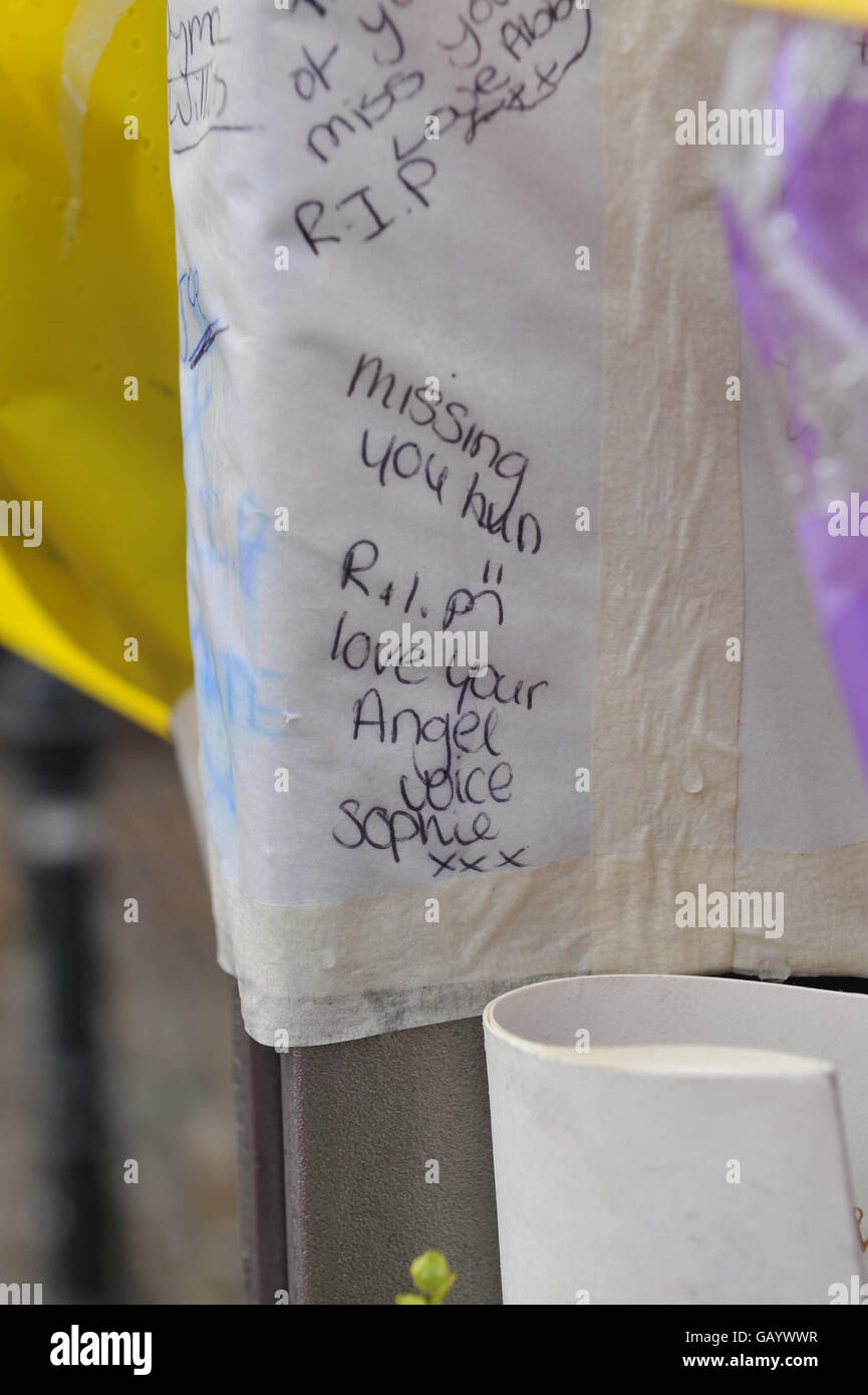 Floral tributes attached to a street information sign on King Street ...