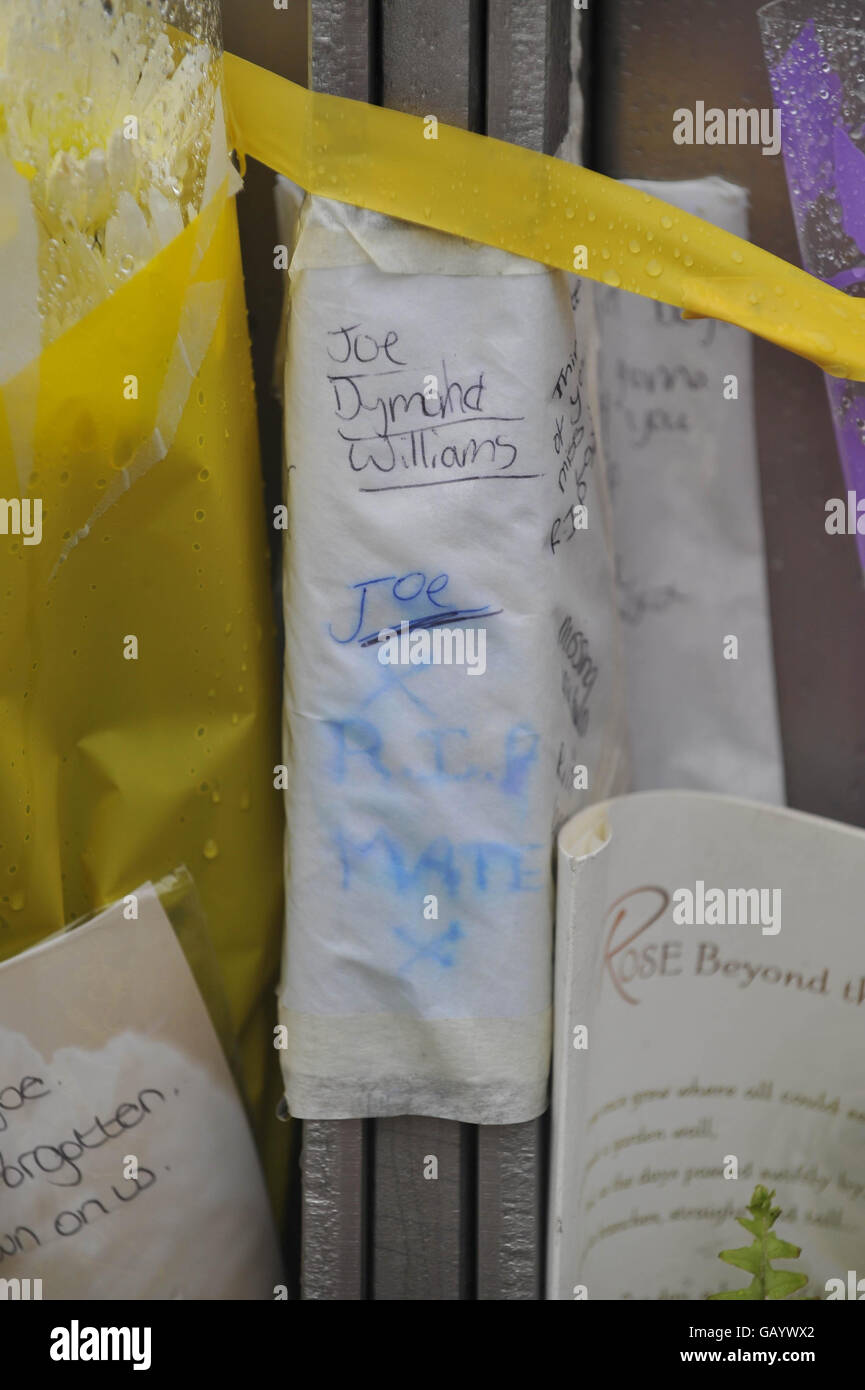 Floral tributes attached to a street information sign on King Street ...