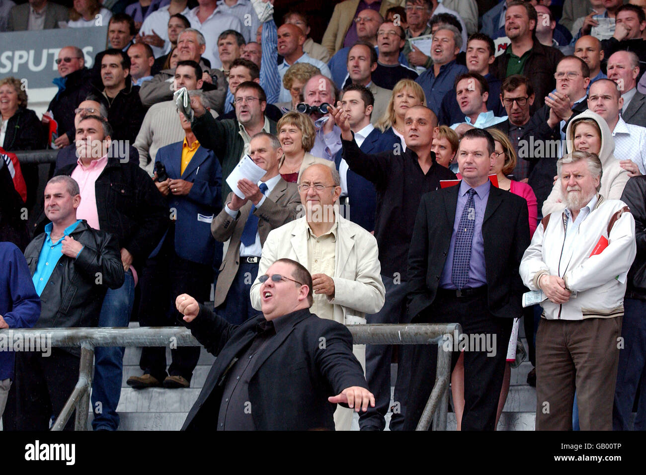 Horse Racing - Epsom - Oaks Day Meeting. A spectator urges his chosen ...