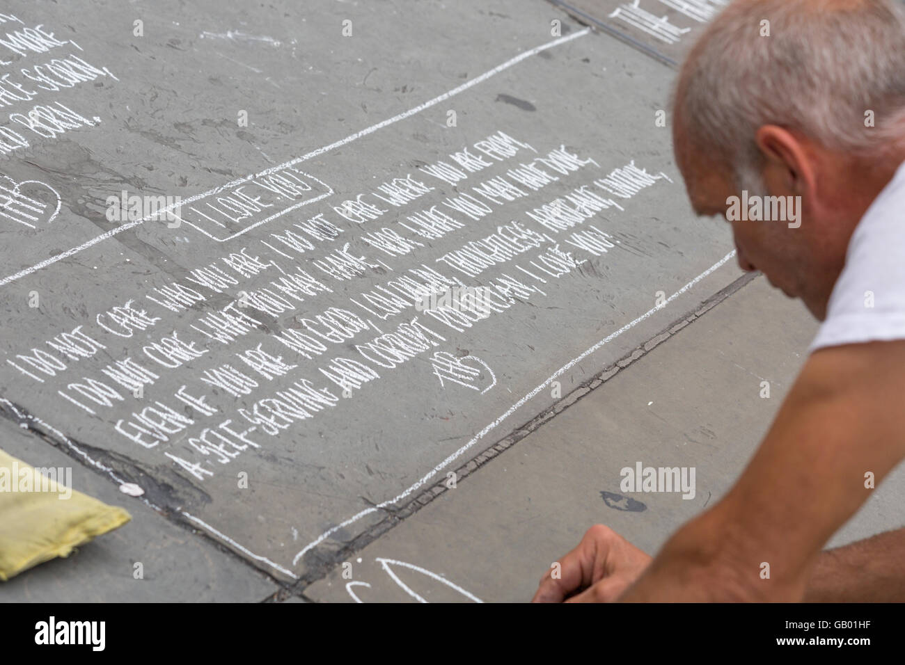 Street artist writing poems in chalk at Trafalgar Square, London in ...