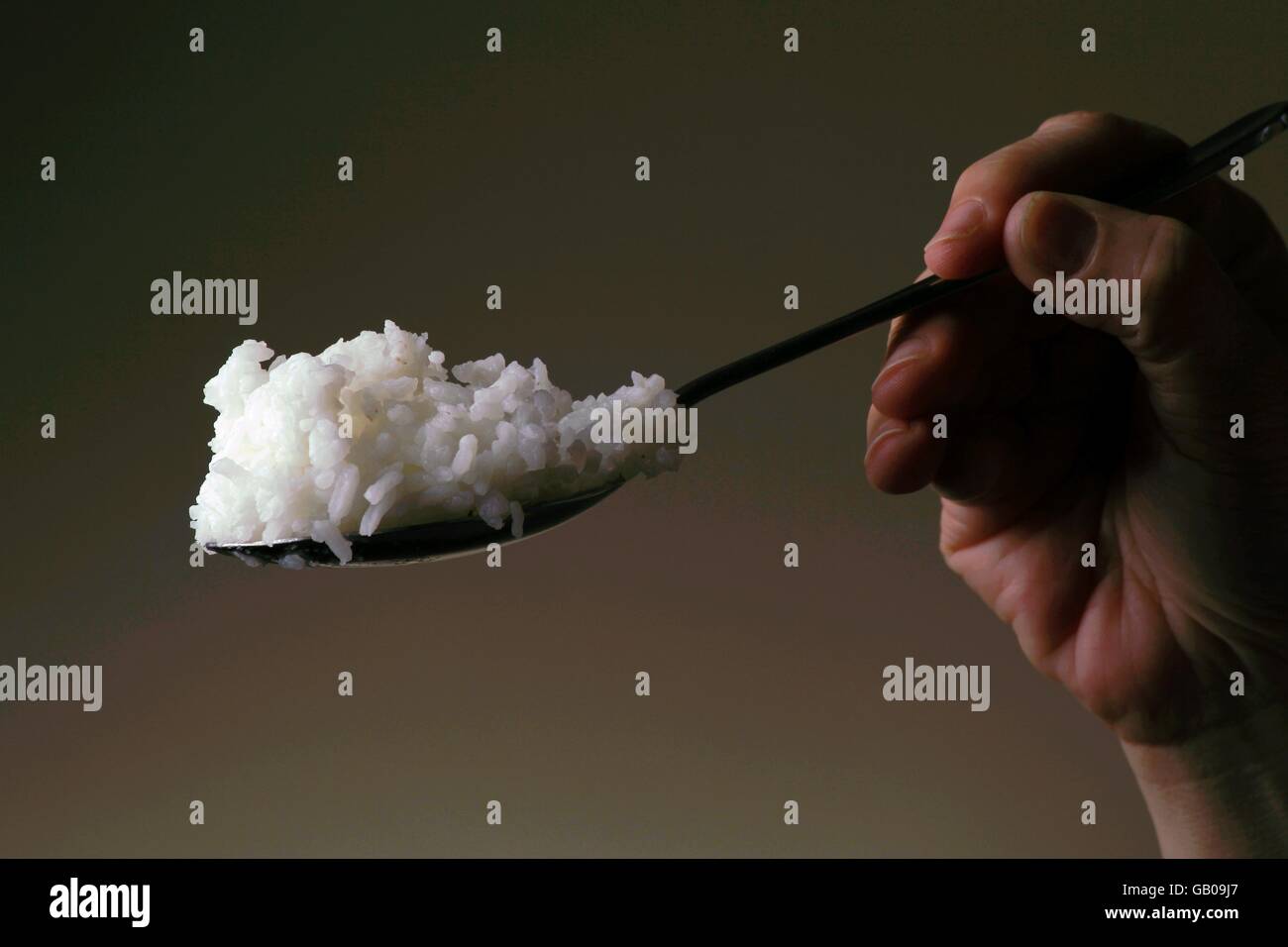 Hand holding silver spoon hi-res stock photography and images - Alamy