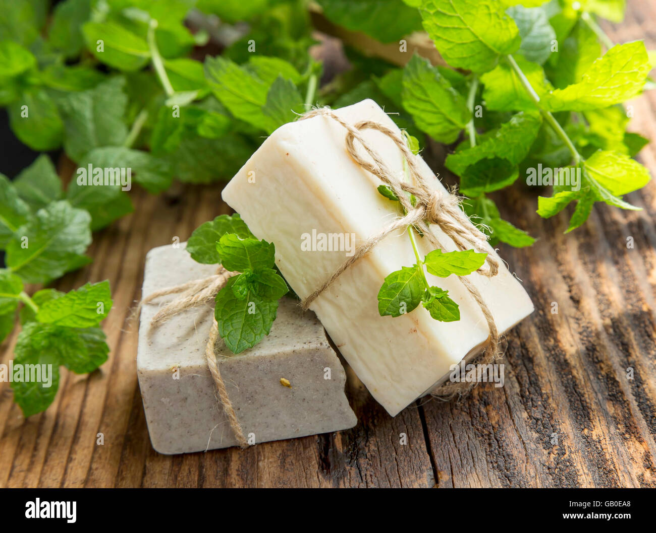Natural organic mint soaps with mint leaves on wooden background Stock ...