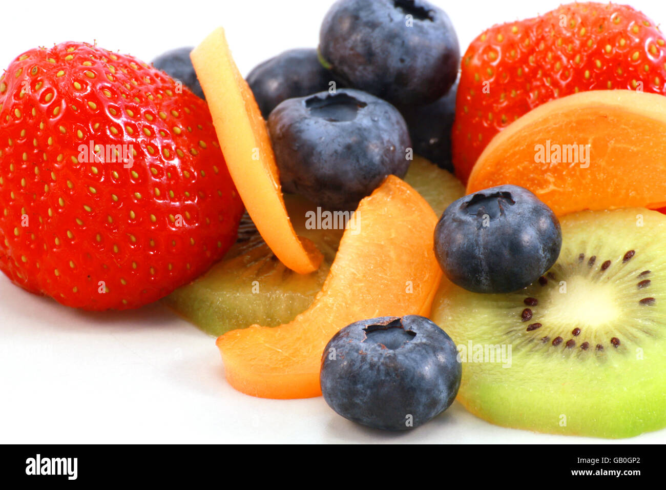 different fruits - strawberry, blueberry and apricot, kiwi - placed ...