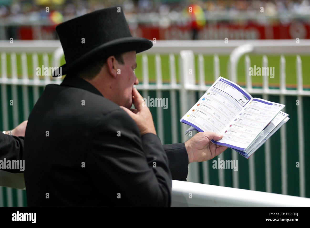 A spectator studies the form guide at Epsom on Derby Day Stock Photo ...