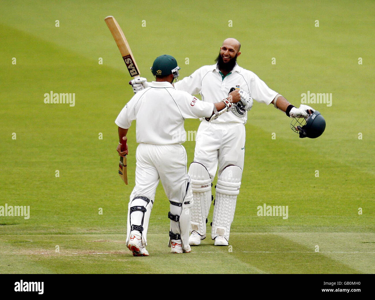 South African batsman Hashim Amla (right) gets his hundred runs and ...